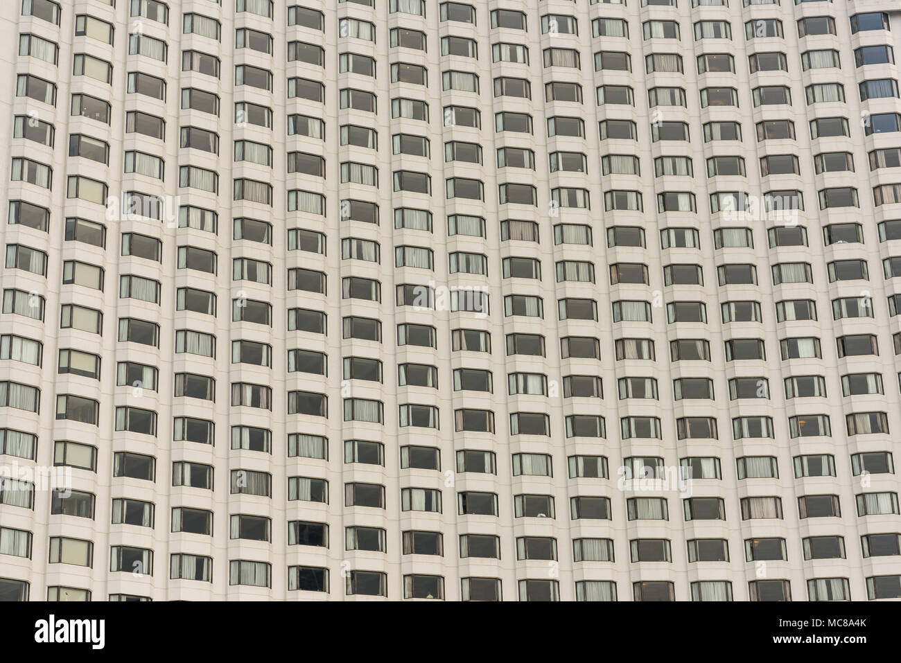 Lots of identical windows on a high rise apartment building on Bangkok ...