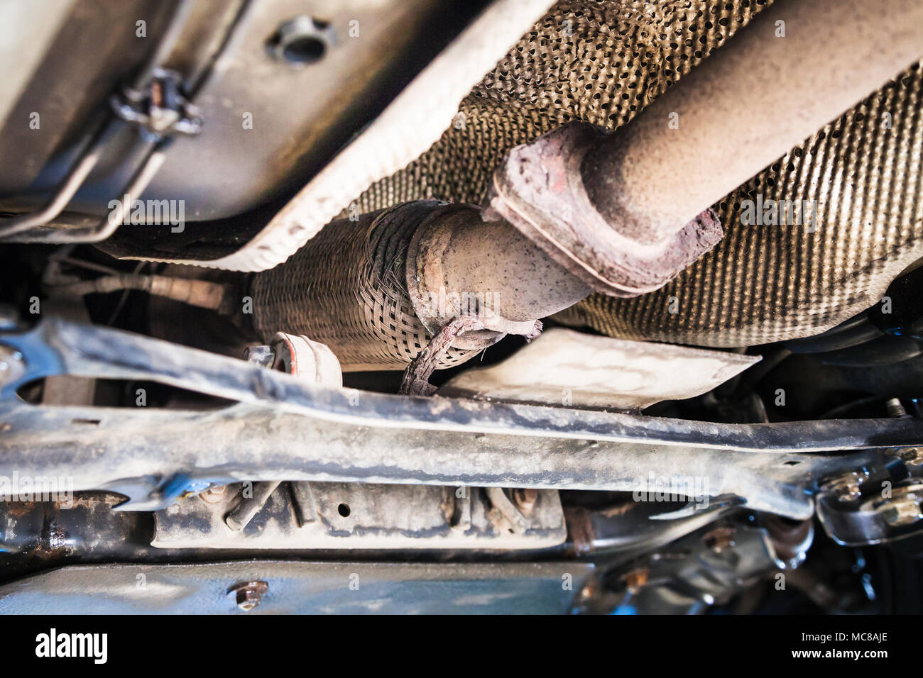 repairing of corrugation muffler of exhaust system in car workshop ...