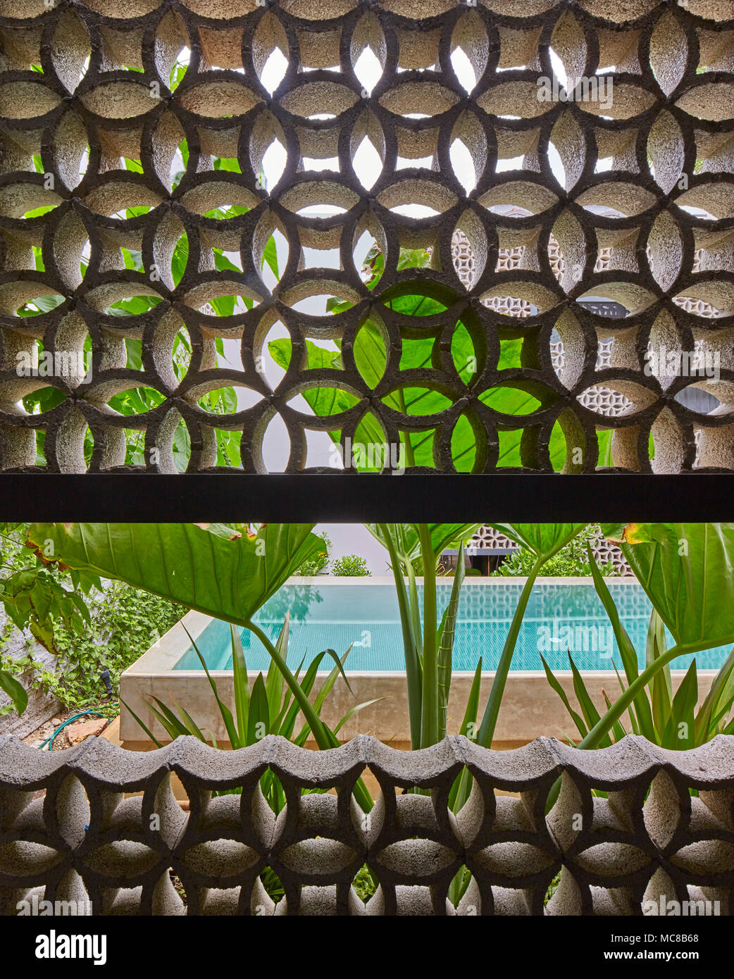 View through ornate brick wall. Merida House 2, Merida, Mexico ...
