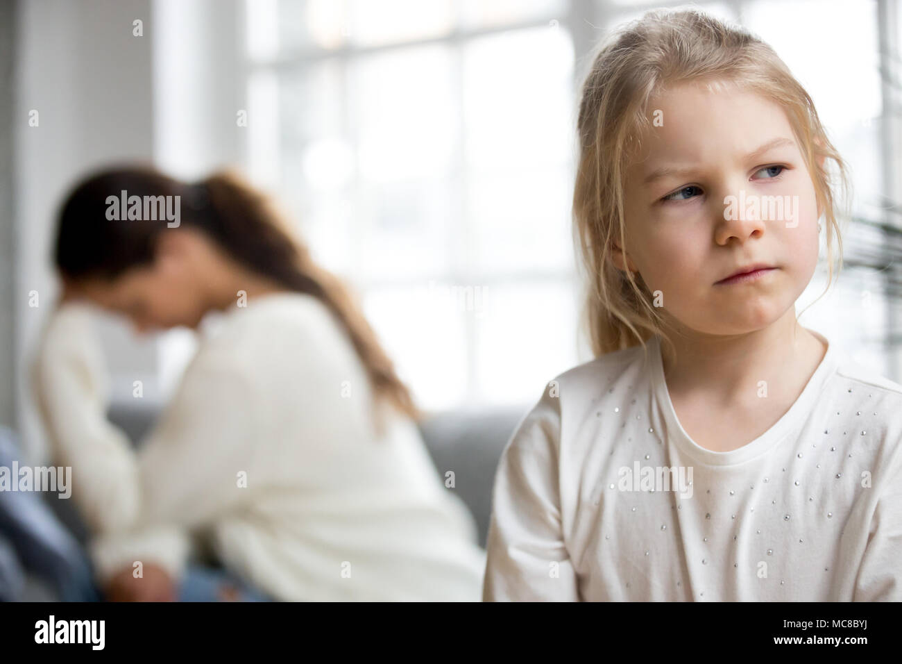 Sulky angry offended child girl pouting not talking to desperate mother ...