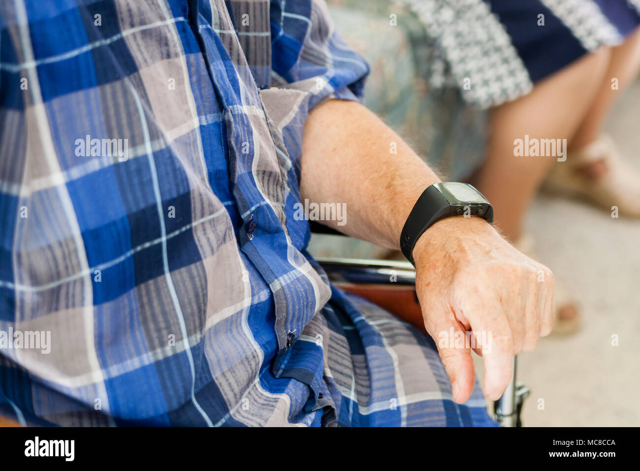 old man is having wearable device smart watch in care home retirement ...