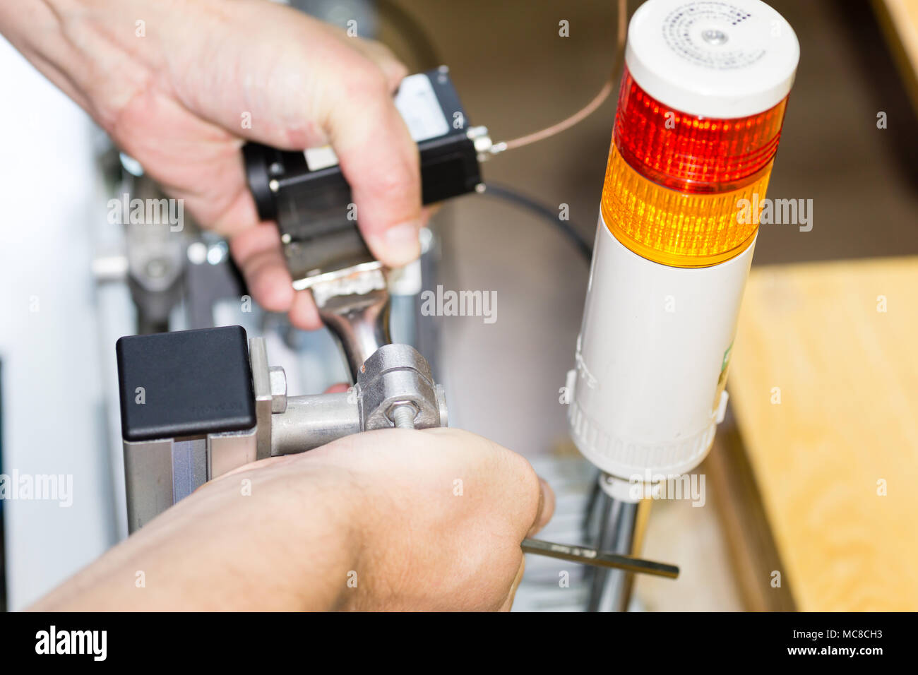 Engineer hands installing robotic machine vision system in factory ...