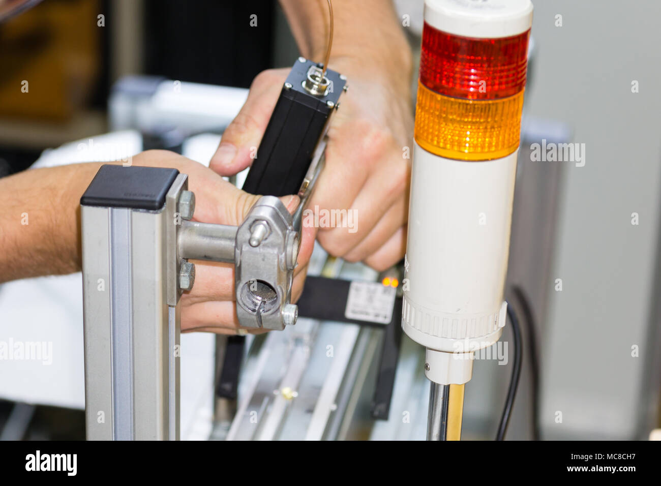 Engineer hands installing robotic machine vision system in factory ...