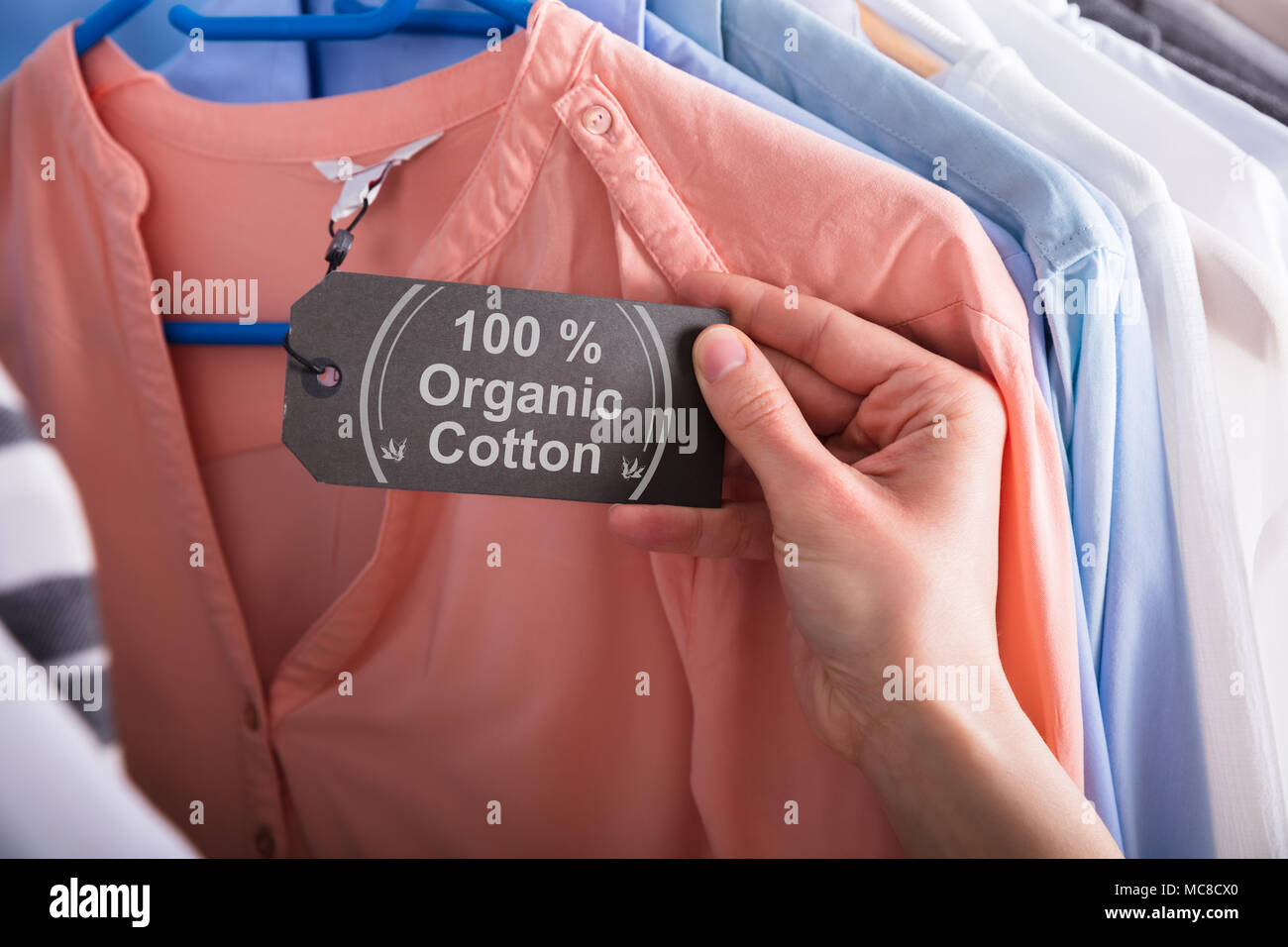 Hand holding hanger hi-res stock photography and images - Alamy