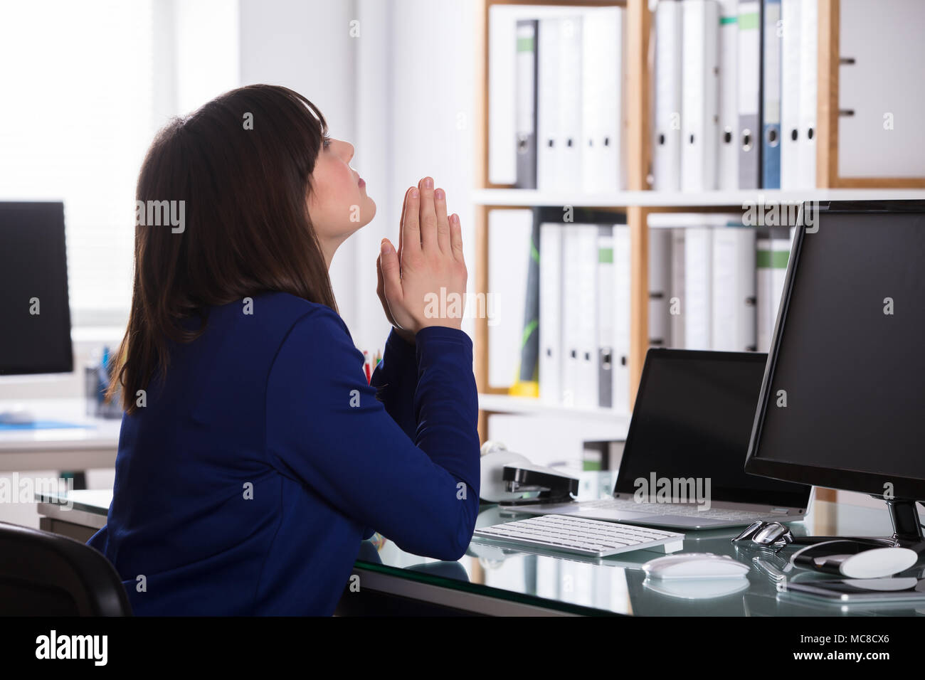 One woman praying looking up hi-res stock photography and images - Alamy