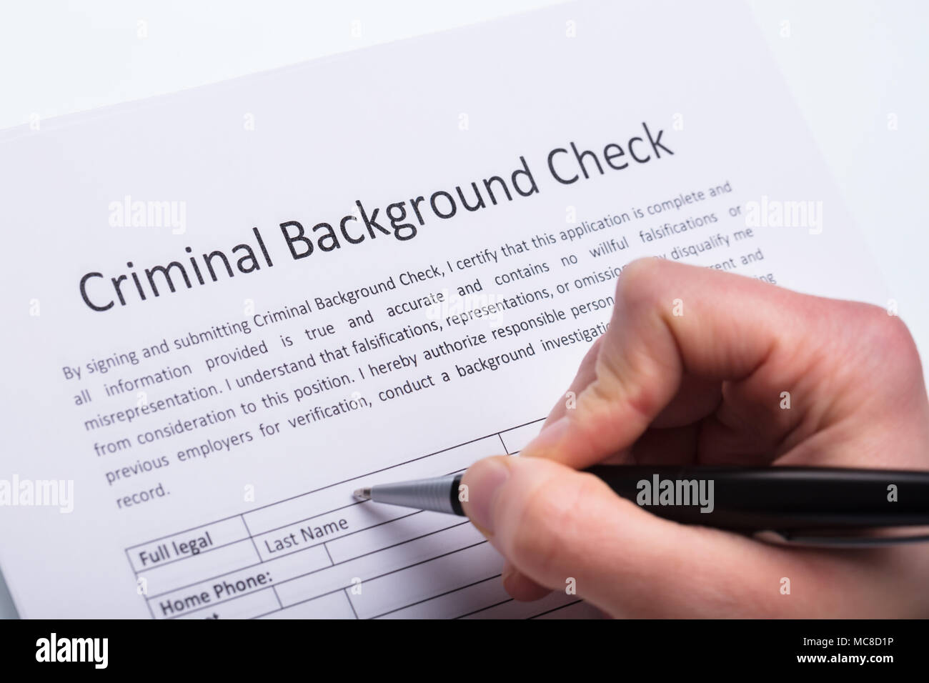 Close-up Of A Person's Hand Filling Criminal Background Check Form With ...