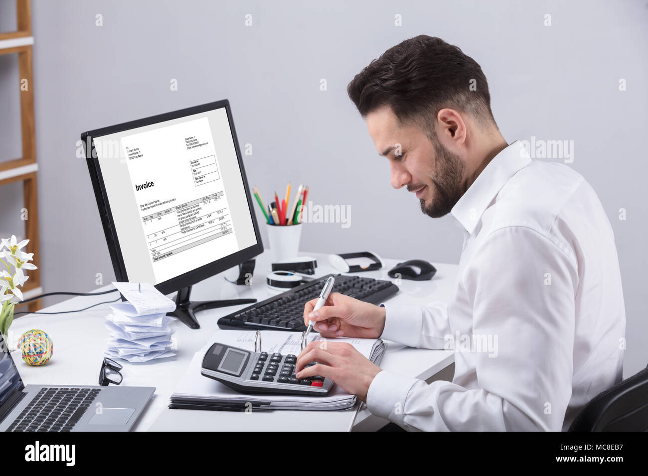 Caucasian business man calculator smiling hi-res stock photography and ...
