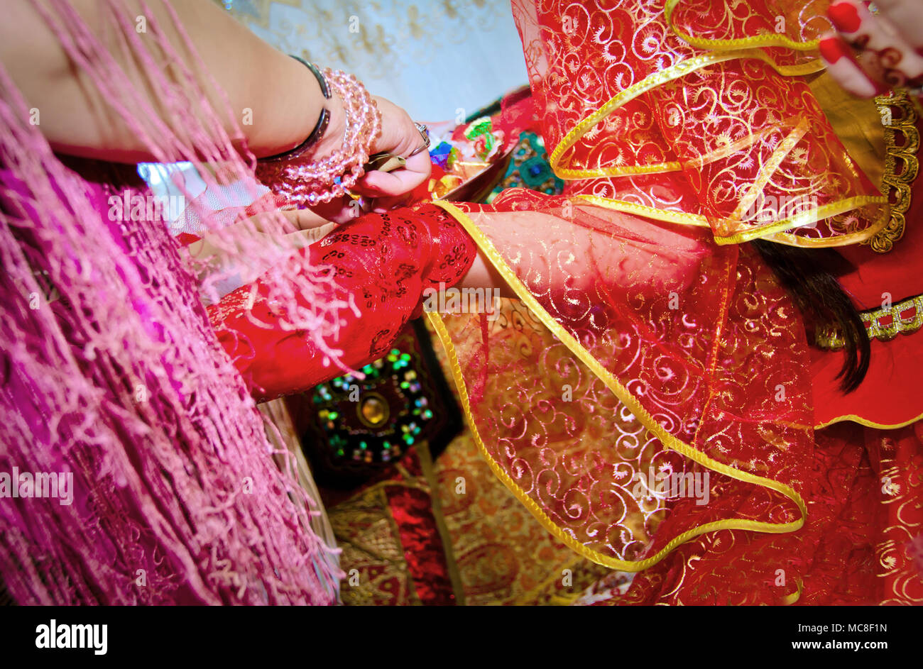 Female hands decoratively colored by henna with cup . Hold a bowl with ...