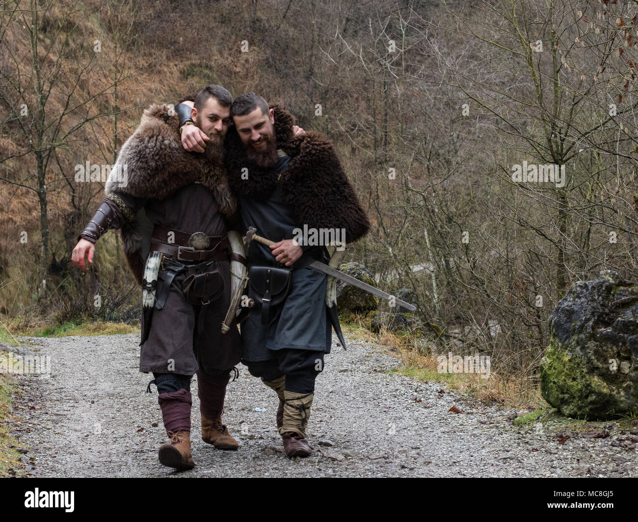 two Viking warriors walk hugged in the forest Stock Photo - Alamy