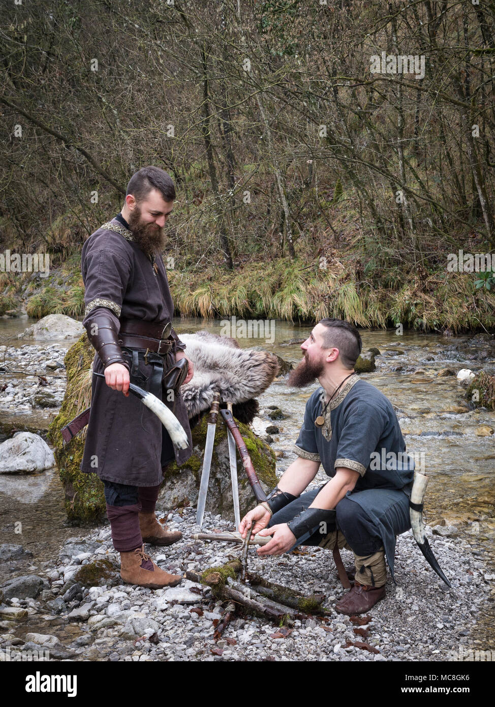 two Vikings in the forest on the banks of the river Stock Photo - Alamy
