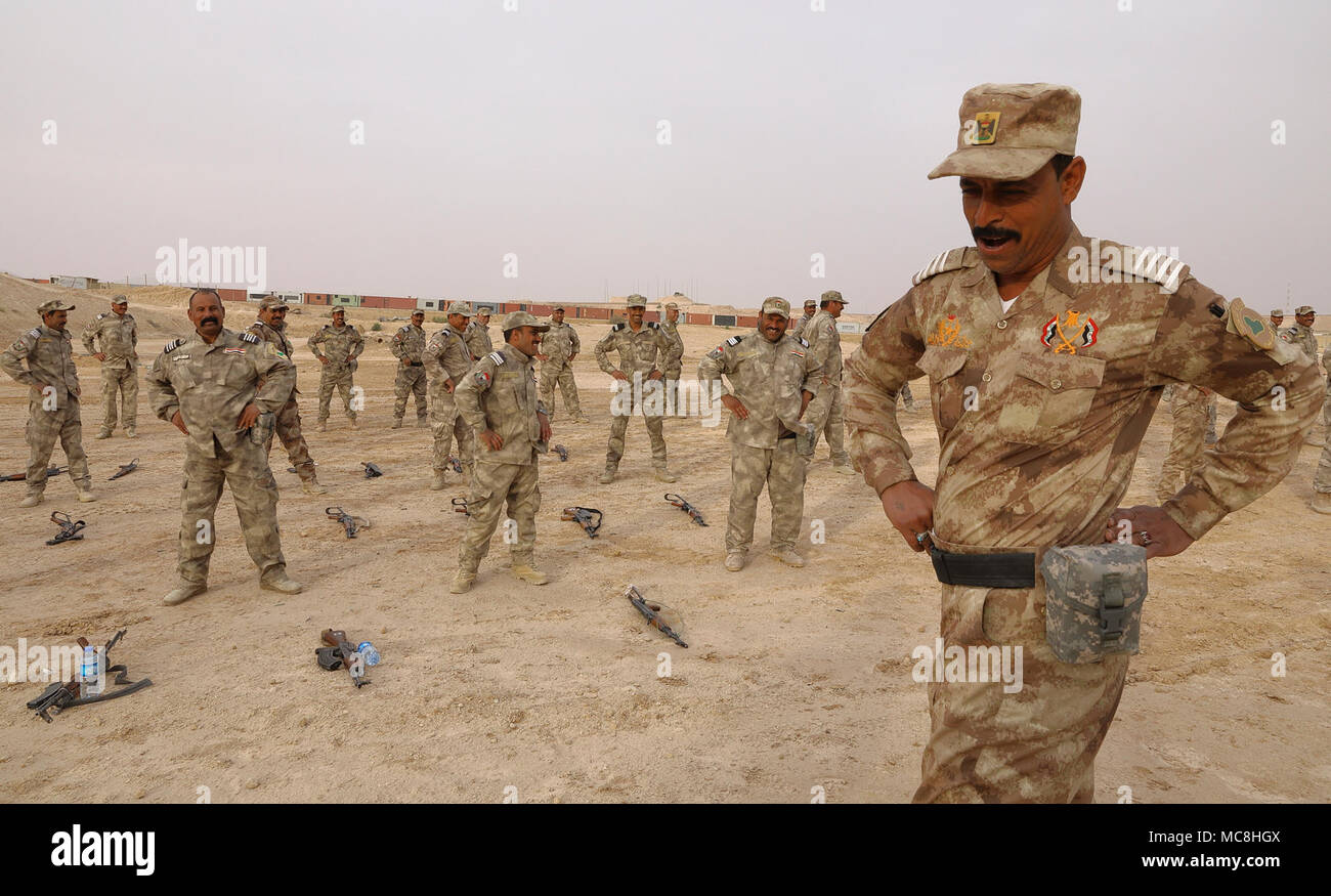 An Iraqi border guard leader conducts physical training with members ...