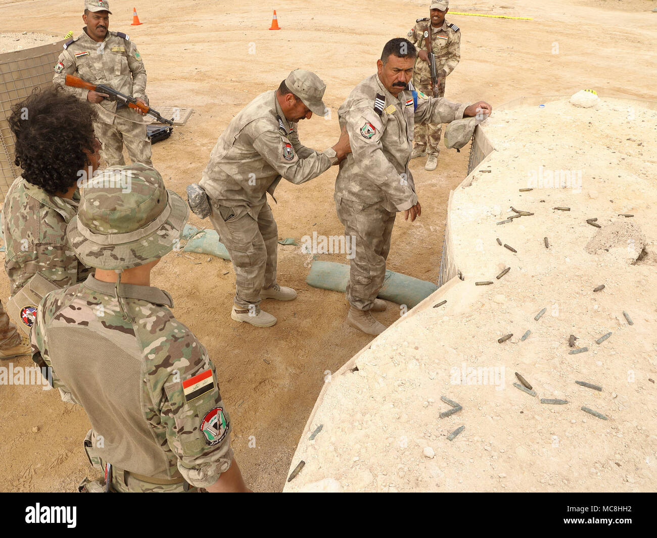 Danish trainers observe Iraqi border guard members as they practice ...