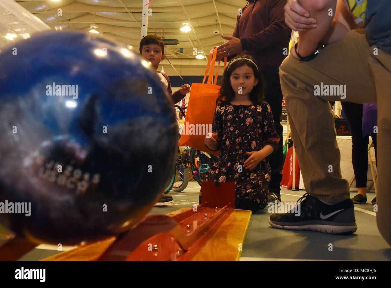 Olivia Cosentino, 6, rolls a bowling ball up a rail during the 50th ...