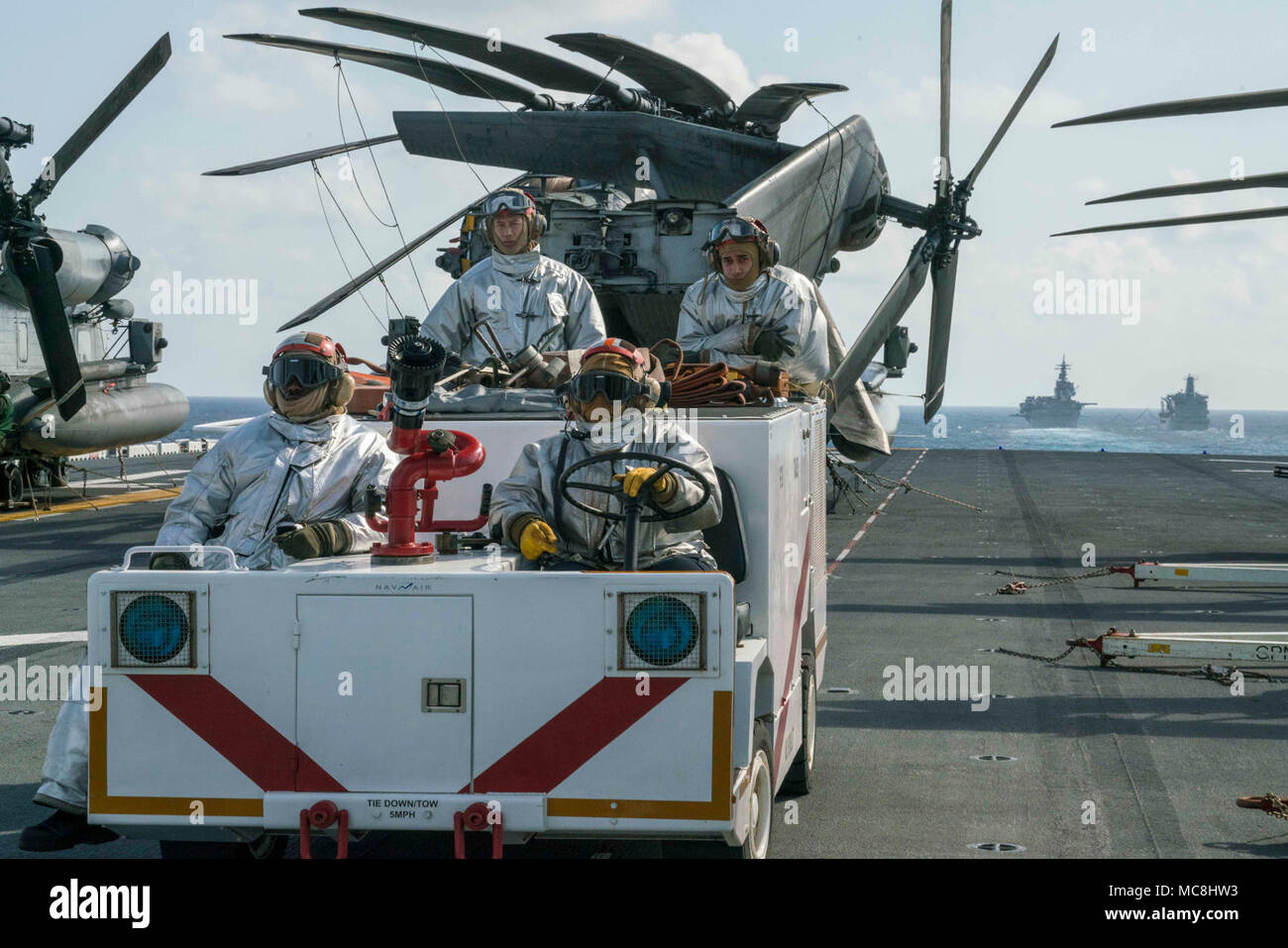 US Navy deck crew on aircraft carrier buggy Stock Photo - Alamy