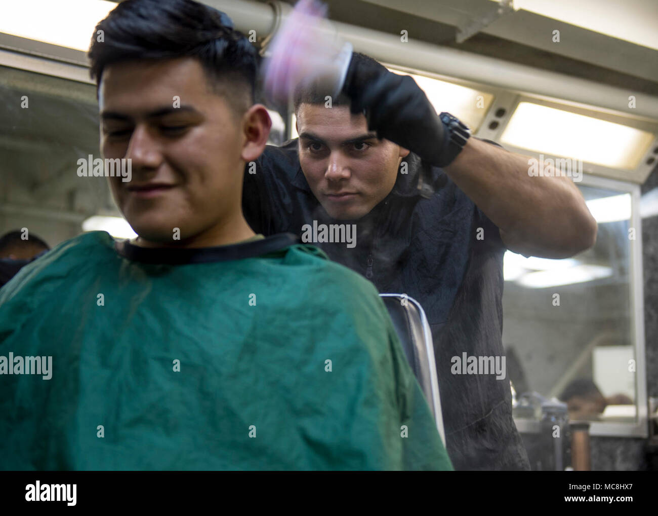 US Navy sailor gets a haircut Stock Photo - Alamy