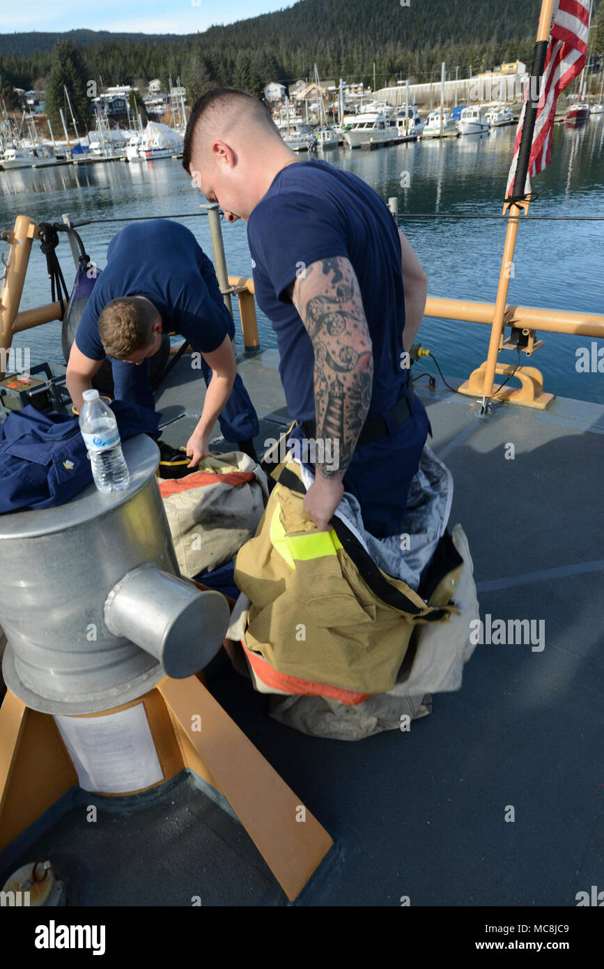 Petty Officer 3rd Class Blake Abraham dons fire fighting turnout gear ...