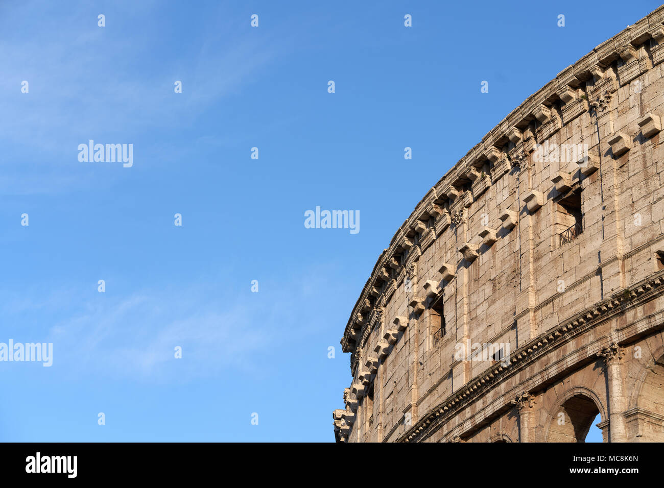 Closeup view of Colosseum amphitheater with blue sky as background in ...