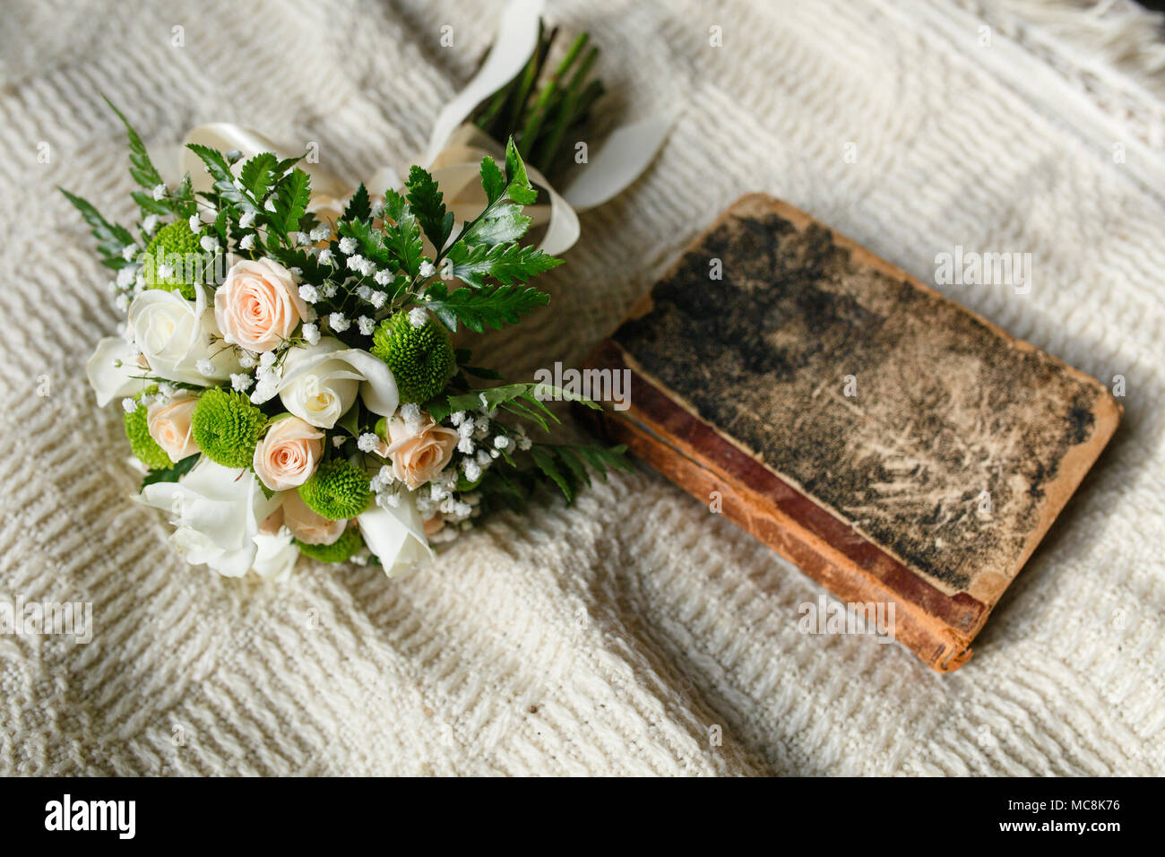 A wedding bouquet of roses, ferns and an old book Stock Photo - Alamy