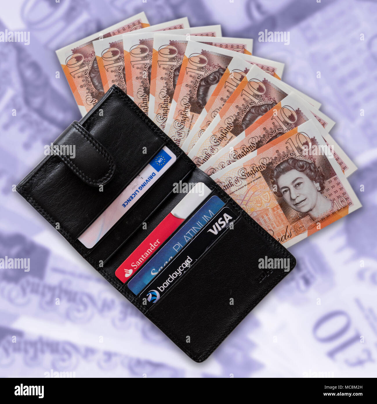 Fanned pound notes and open wallet Stock Photo - Alamy