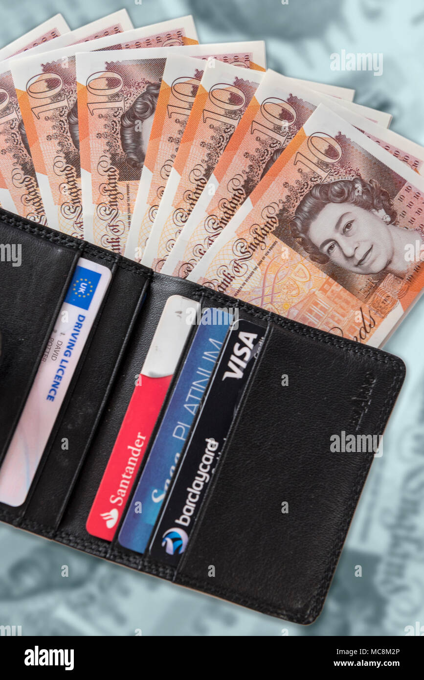 Fanned pound notes and open wallet Stock Photo - Alamy