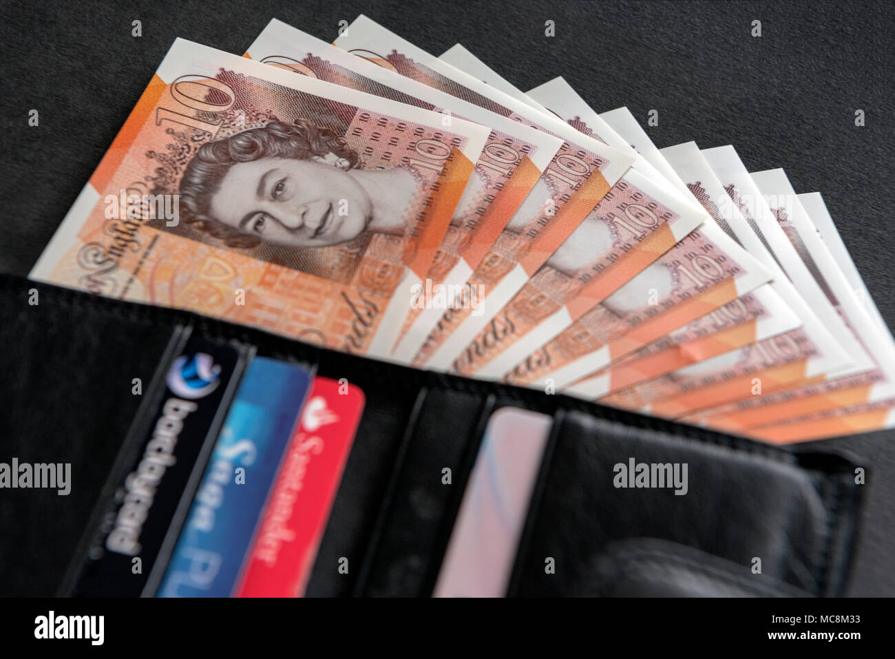 Fanned pound notes and open wallet Stock Photo - Alamy