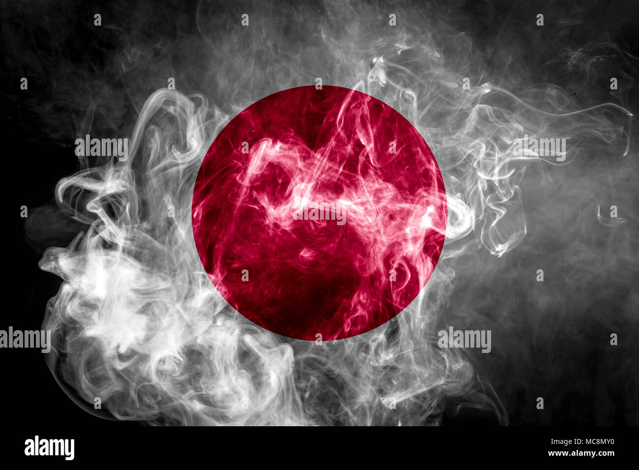 National flag of Japan from thick colored smoke on a black isolated ...