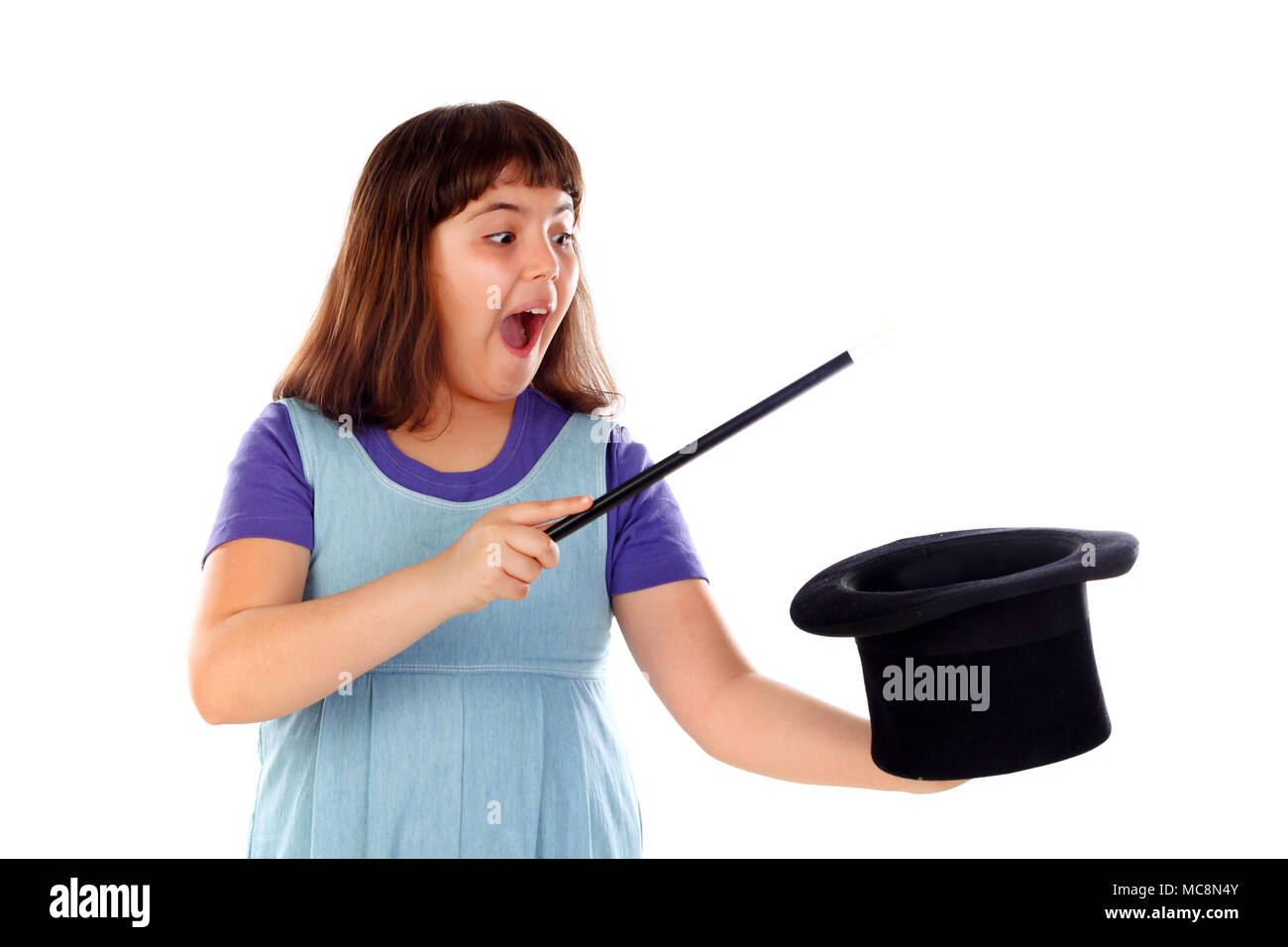 Pretty little girl doing magic with a top hat and a magic wand isolated ...