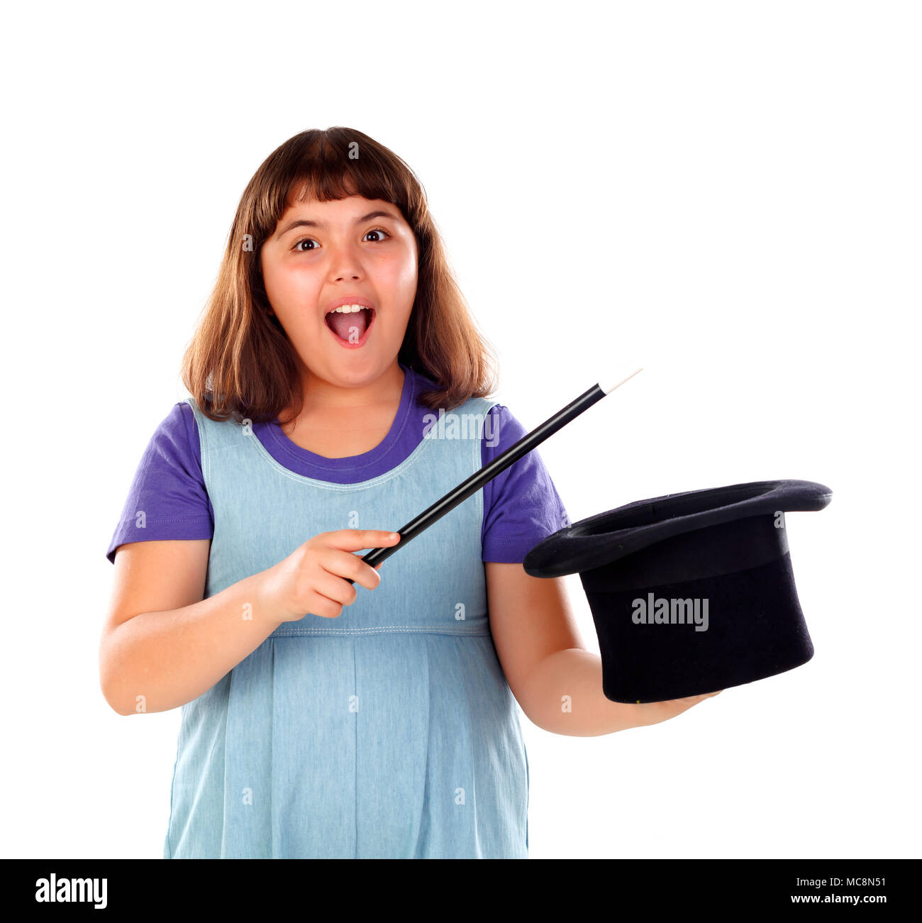 Pretty little girl doing magic with a top hat and a magic wand isolated ...