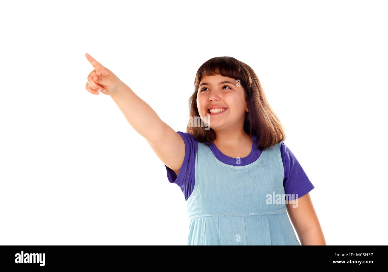 Smiling girl pointing something with her finger isolated on a white ...