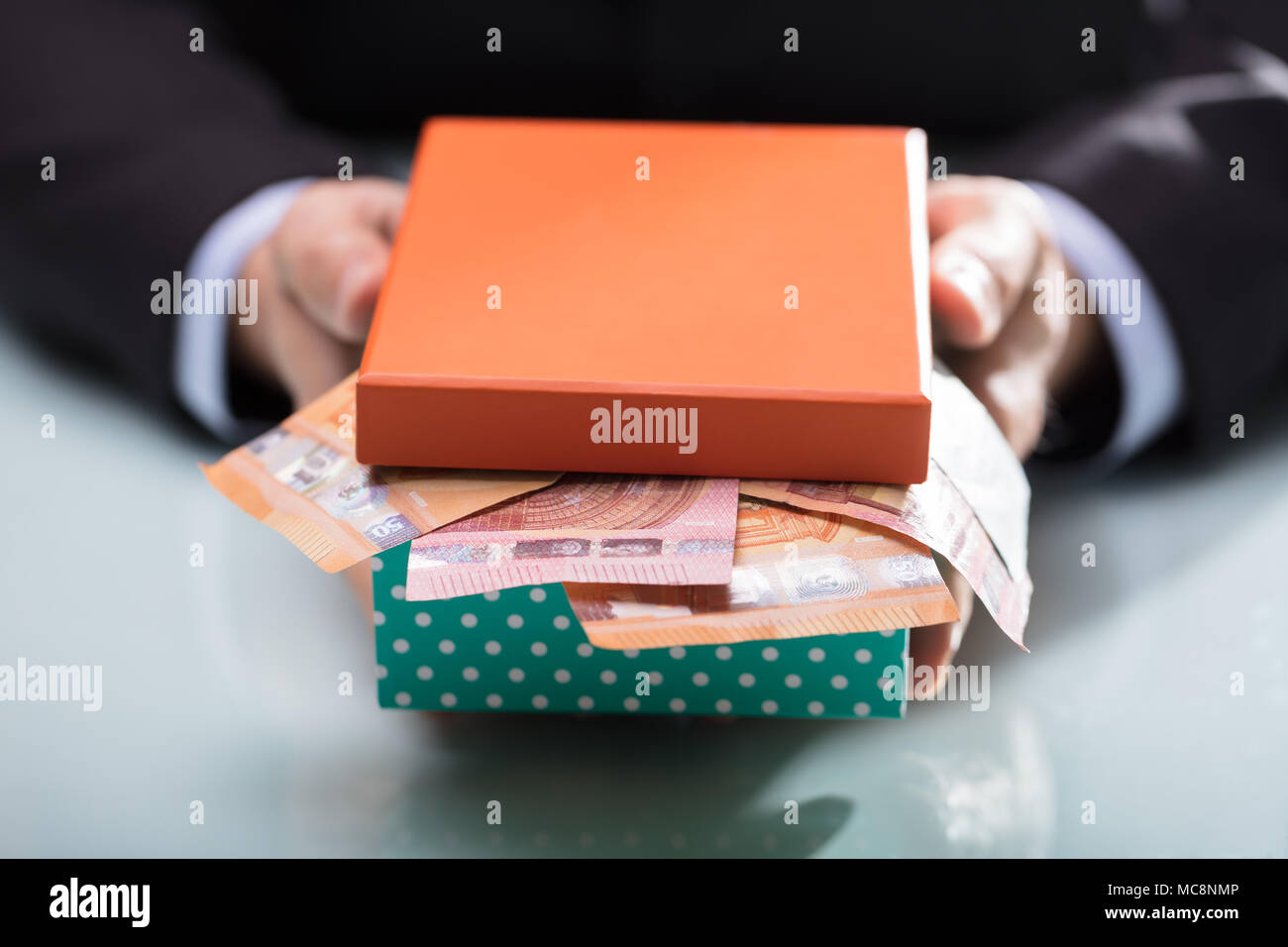 Close-up Of A Businessperson's Hand Holding Currency Notes And Boxes ...