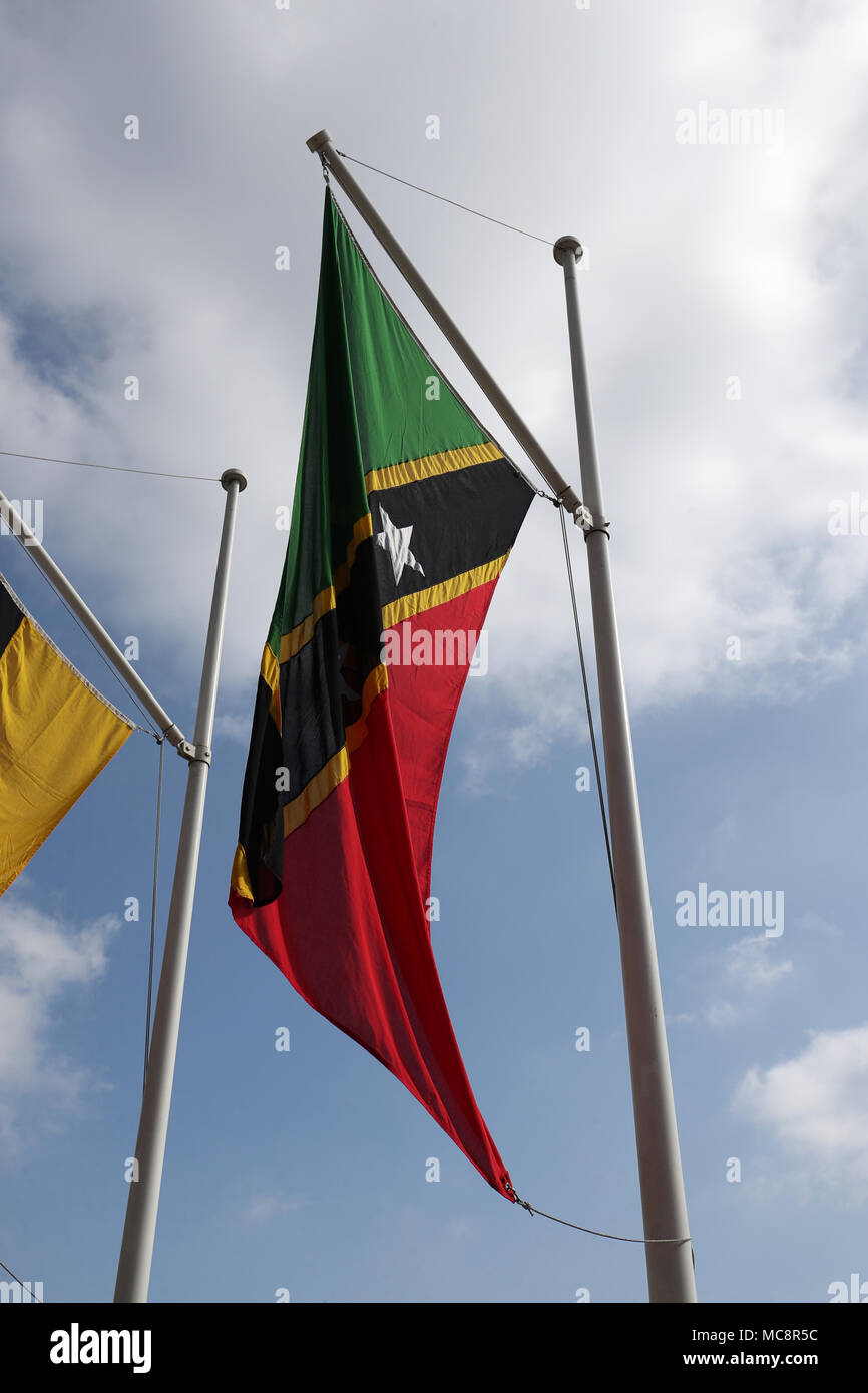 The flag of St. Kitts & Nevis flies with other flags from countries of ...