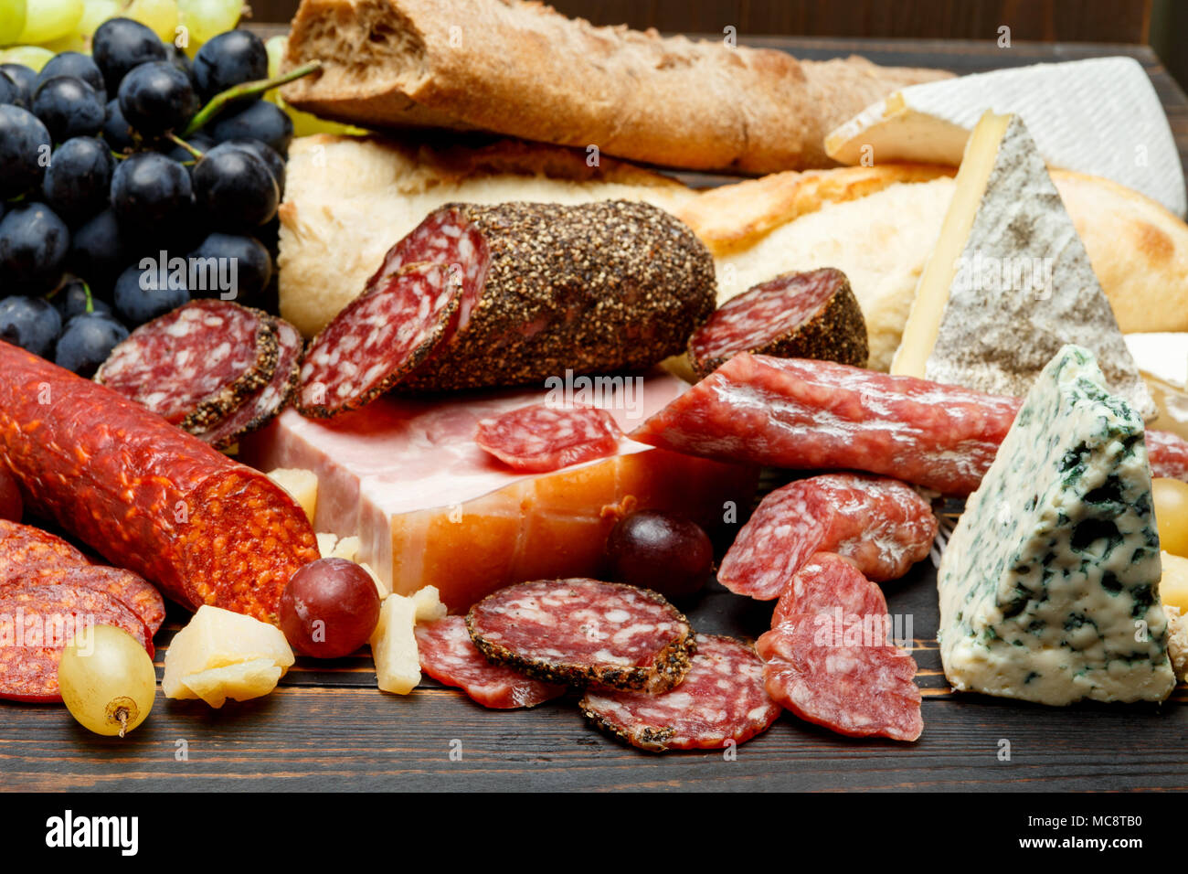 Traditional italian products with salami, cheese, bread and fruits ...
