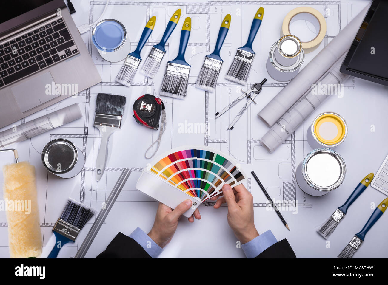 Elevated View Of An Architect's Hand Holding Color Guide Swatch On ...