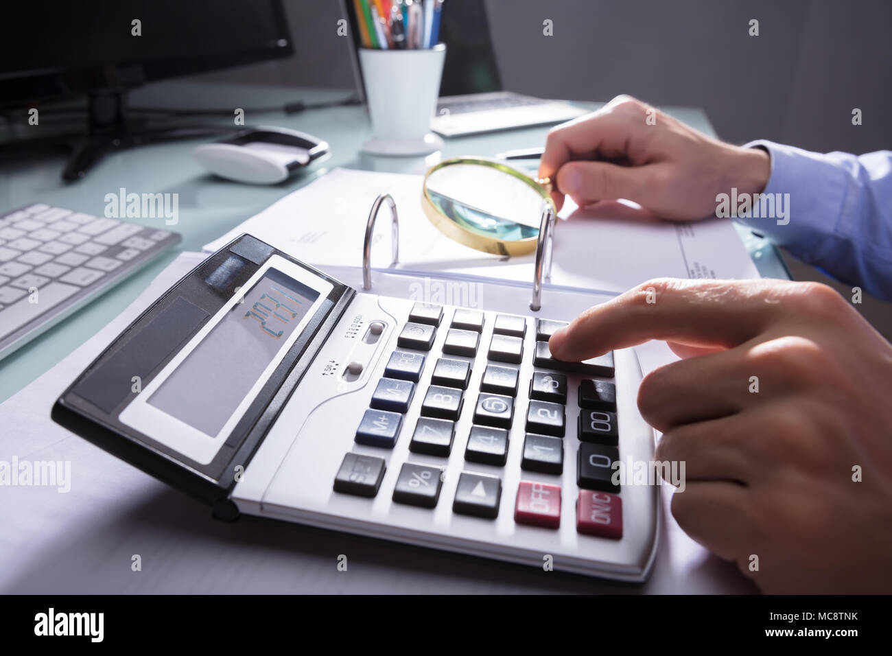 Businessperson's Hand Using Calculator While Checking Bill With ...