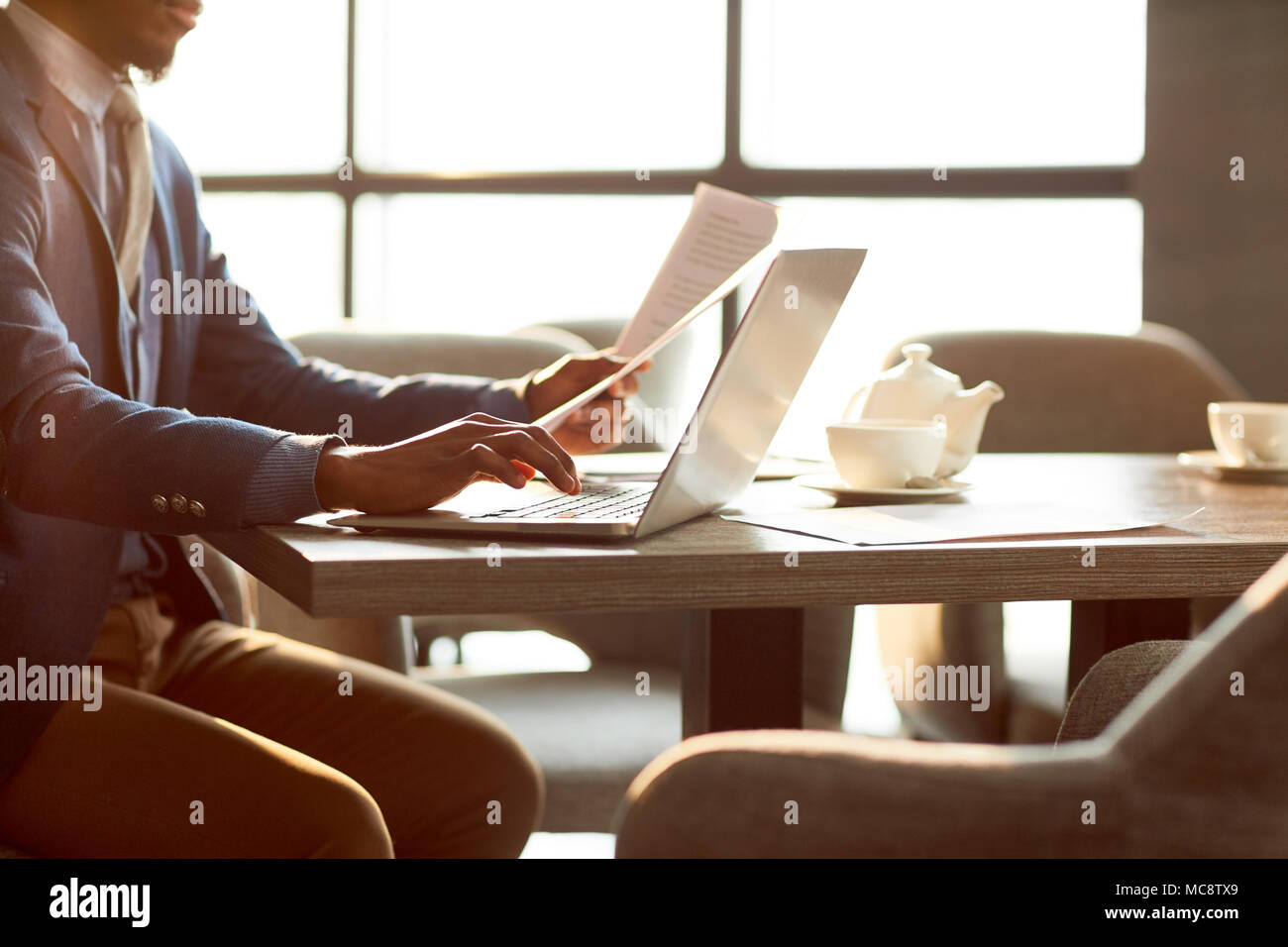 Mobile agent browsing in the net in front of laptop and working with ...