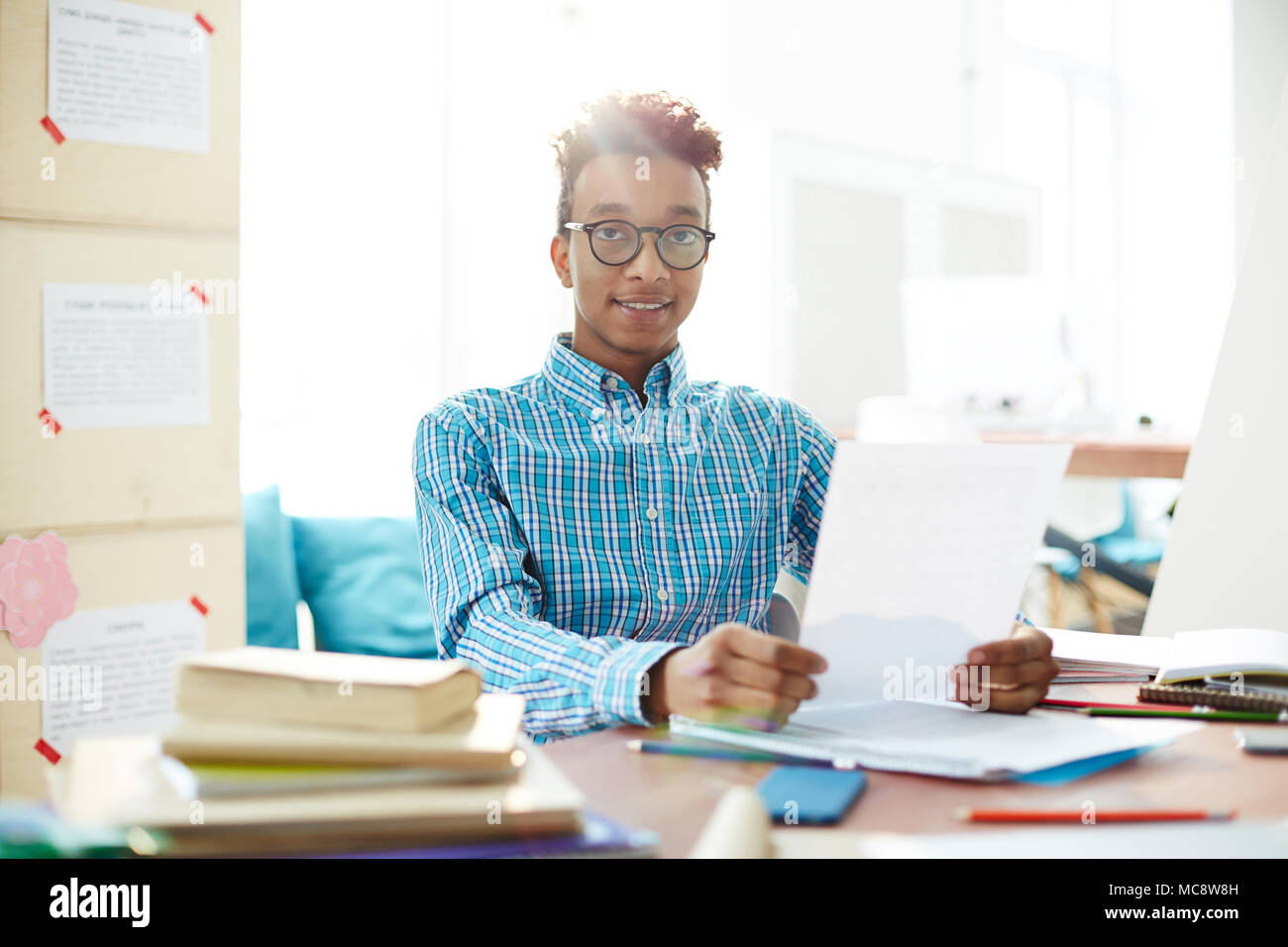 African guy reading paper hi-res stock photography and images - Alamy