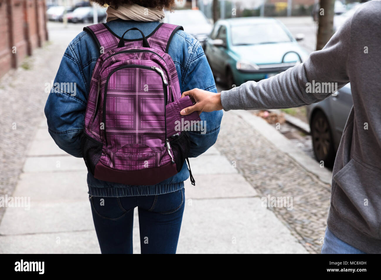 Close-up Of A Thief's Hand Stealing Purse From Backpack Stock Photo - Alamy
