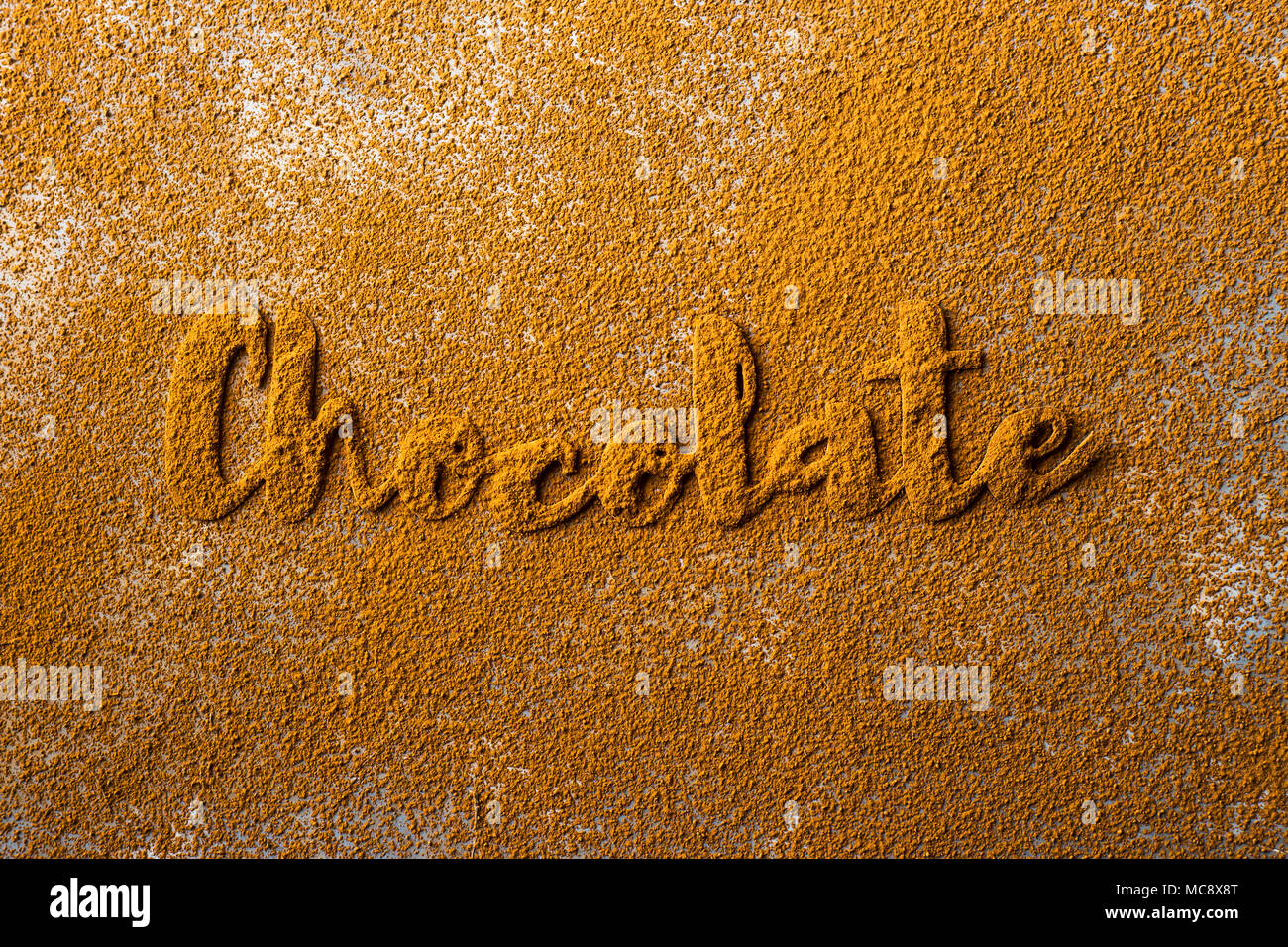 The word chocolate is lined with beautiful cocoa letters on the ...