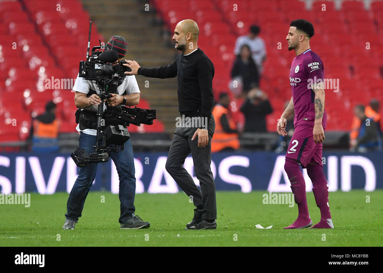 Manchester City manager Pep Guardiola puts his hand on the lens of a ...
