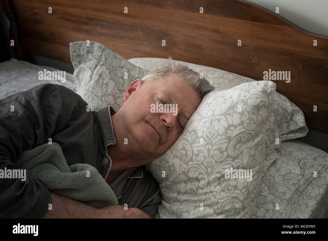 Senior man sleeping in bed hi-res stock photography and images - Alamy