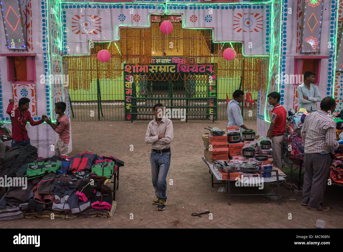 Men standing around the lit facades set up for Sonepur Mela, Sonepur ...