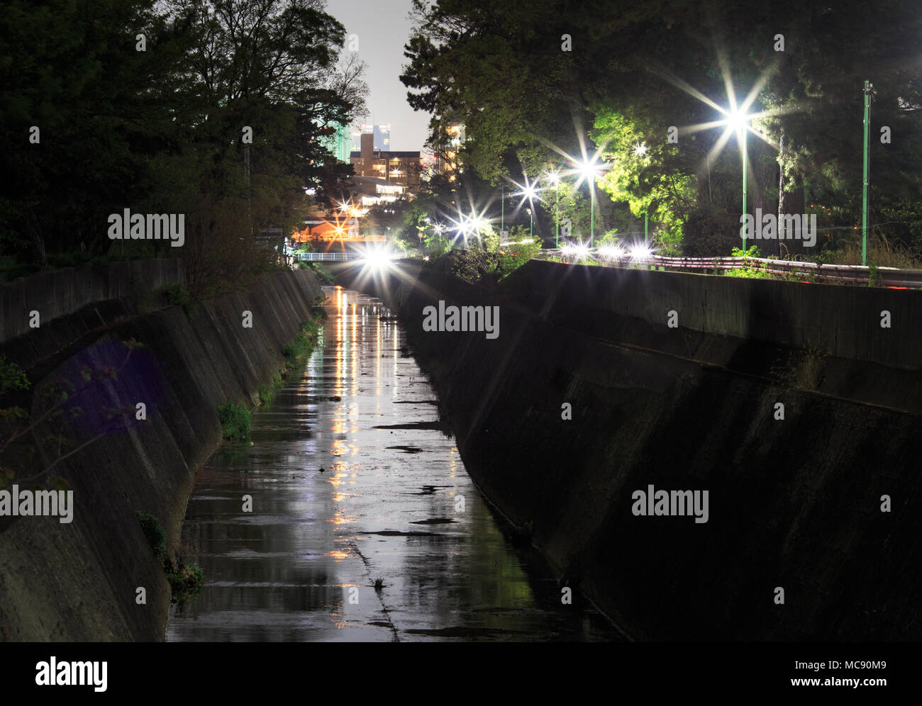 Urban drainage canal flows through the outskirts of Osaka, Japan Stock ...