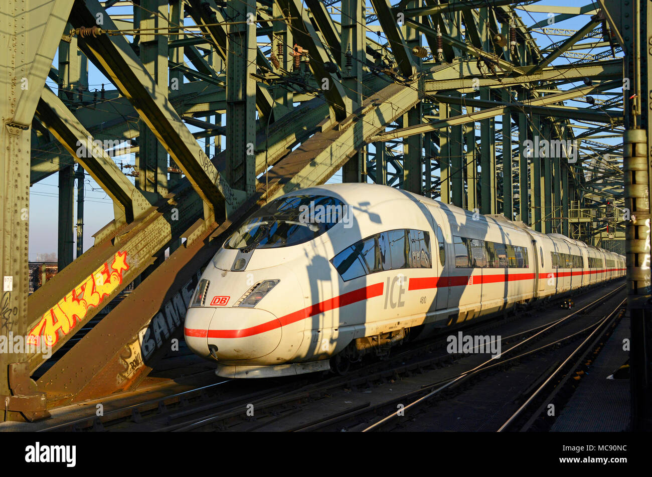 An ICE 3 high speed train service crosses the Rhine Hohenzollern bridge ...