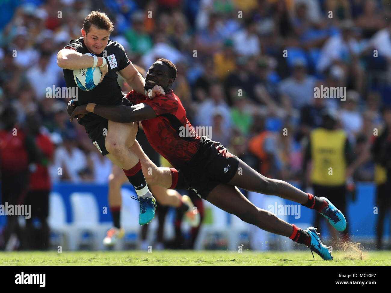 Kenya's Nelson Oyoo (right) tackles Wales' Hallam Amos in the Men's ...