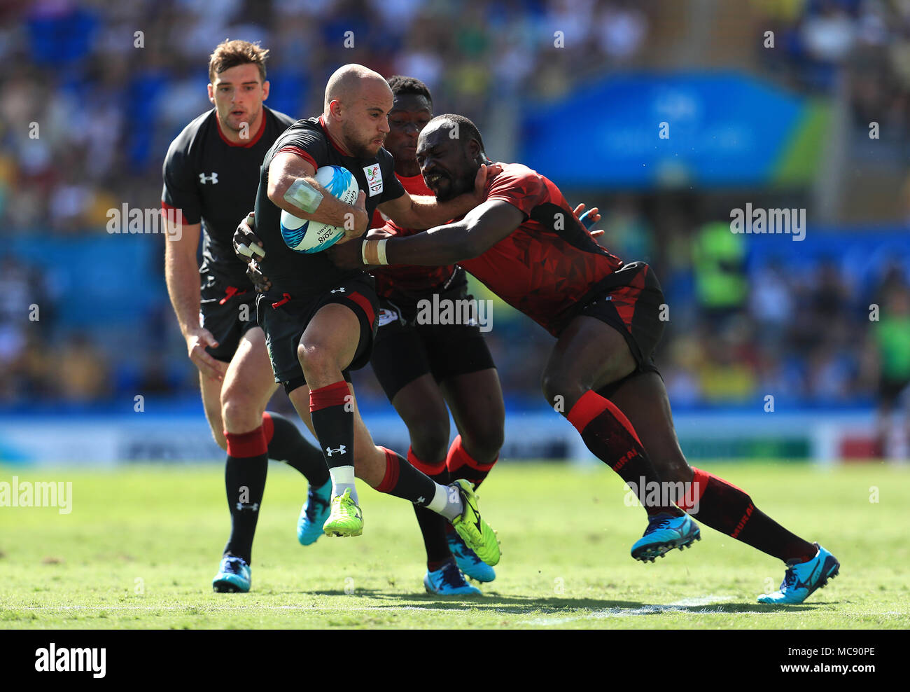 Kenya's Daniel Sikuta (right) tackles Wales' Luke Treharne in the Men's ...