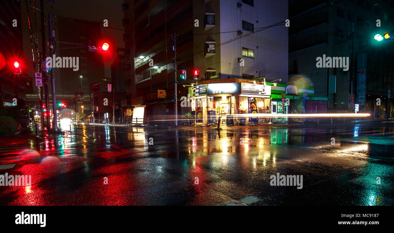 Osaka, Japan - April 14, 2018: Car lights on a quiet street in heavy ...