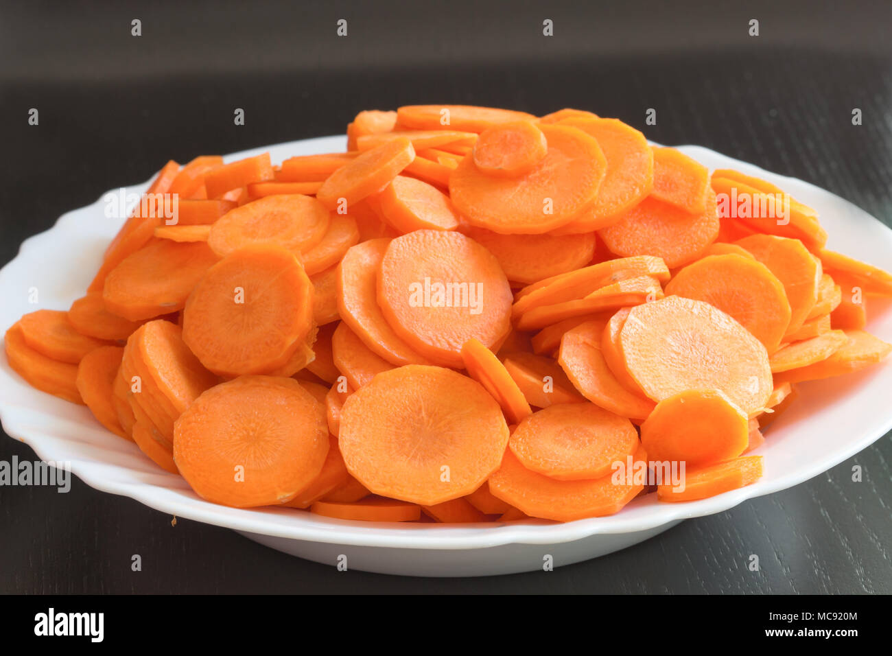 Fresh carrot sliced on a white plate background Stock Photo - Alamy