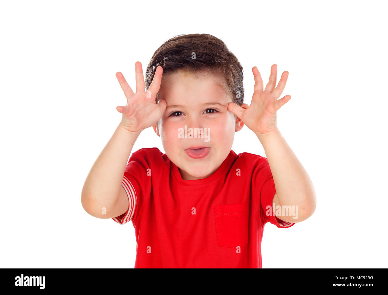 Funny boy with red shirt making fun looking at camera isolated on a ...