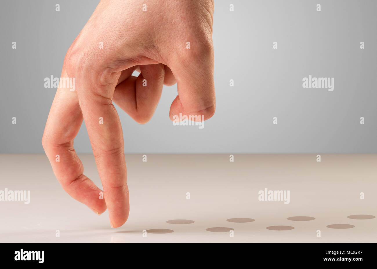 Female fingers walking with dots behind them Stock Photo - Alamy