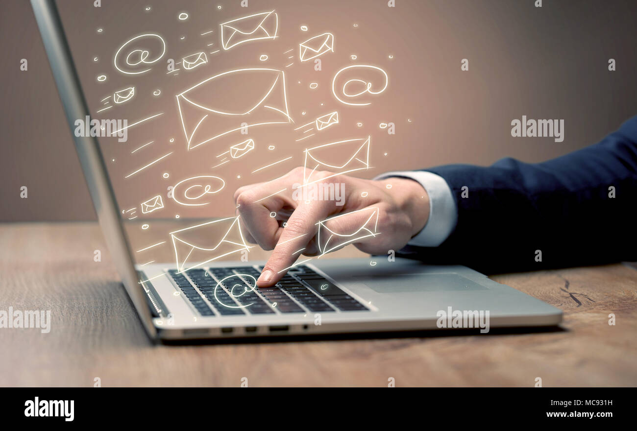 An office worker sending emails and communication with clients with the ...
